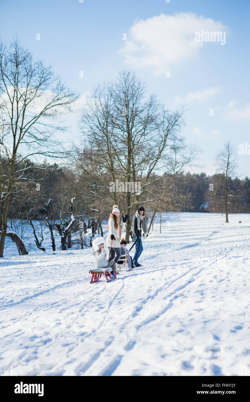 Family playing with sled Stock Photo - Alamy