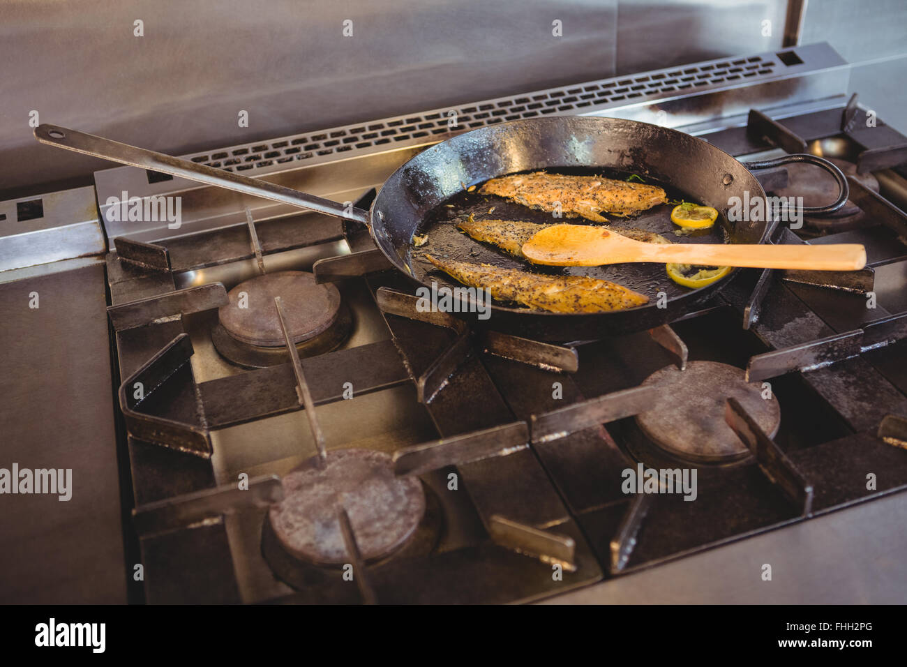 Fish frying in a pan Stock Photo - Alamy