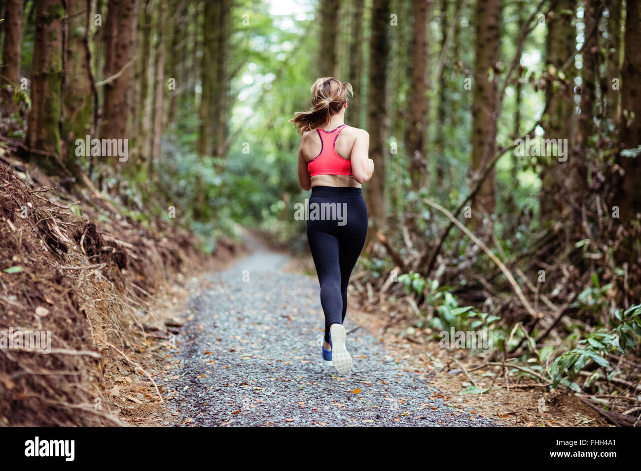 Pretty blonde woman running Stock Photo - Alamy