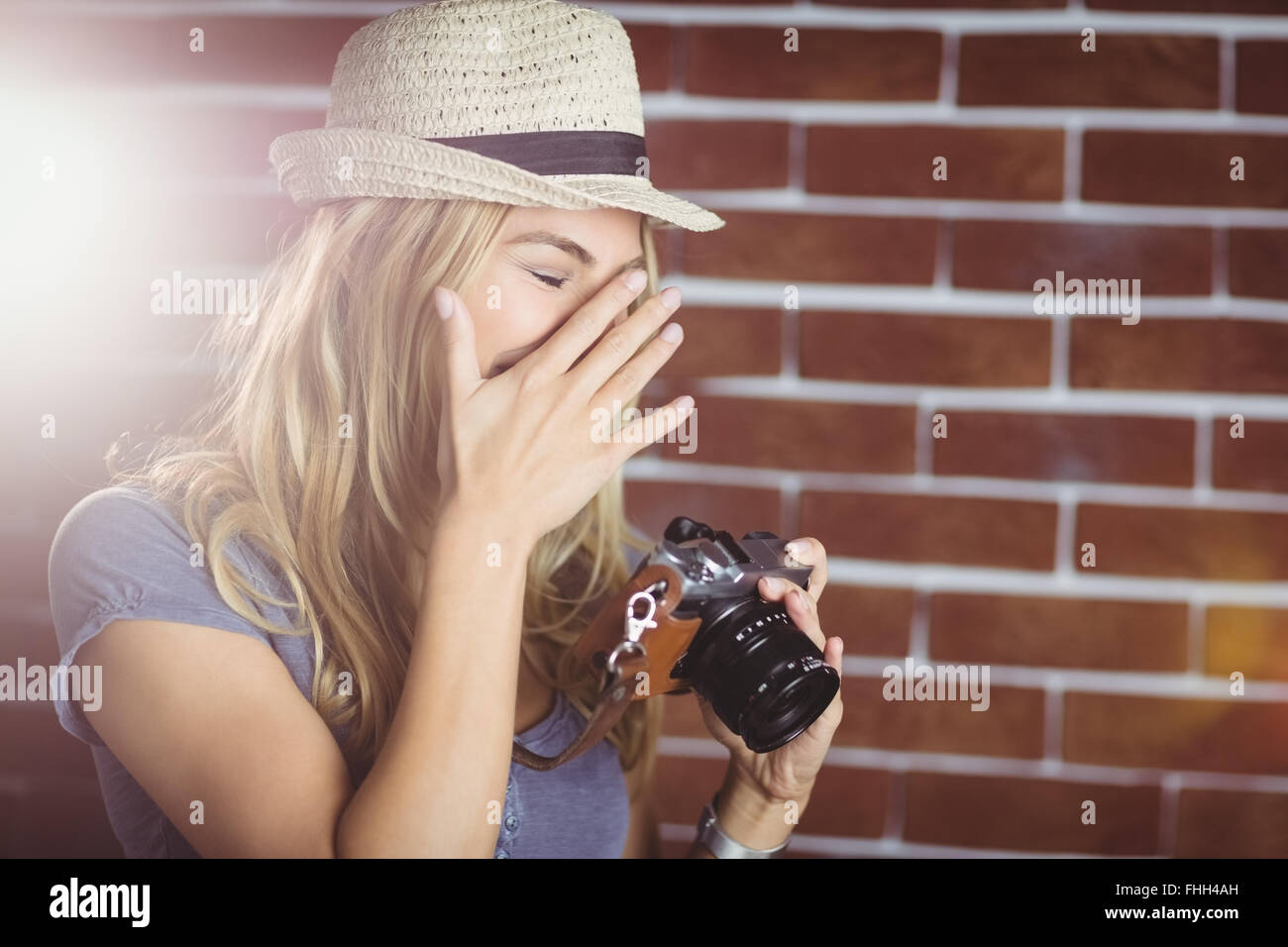 Blonde woman taking picture Stock Photo - Alamy