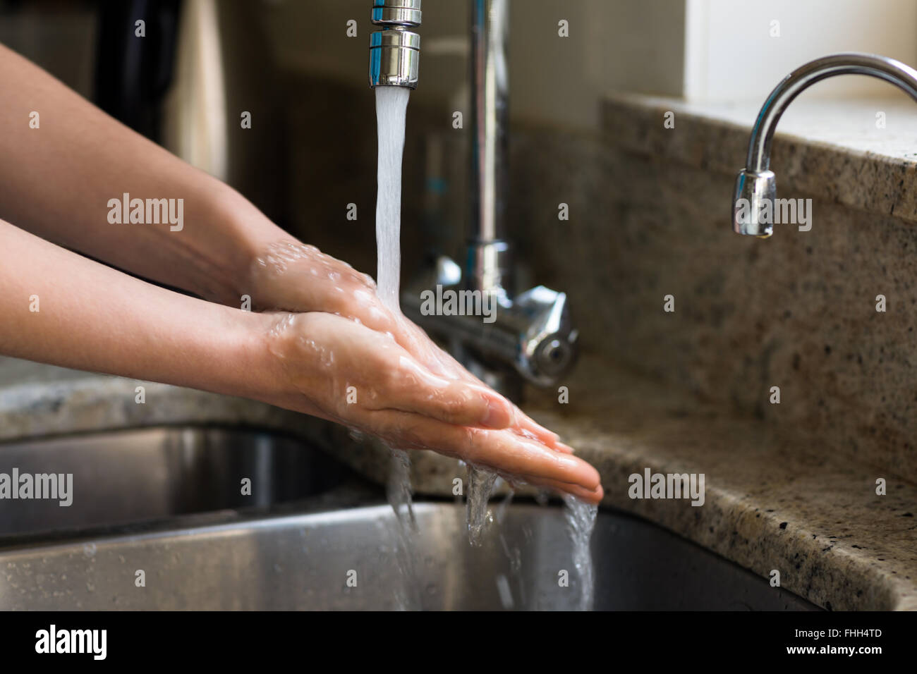 Pretty woman washing her hands Stock Photo - Alamy