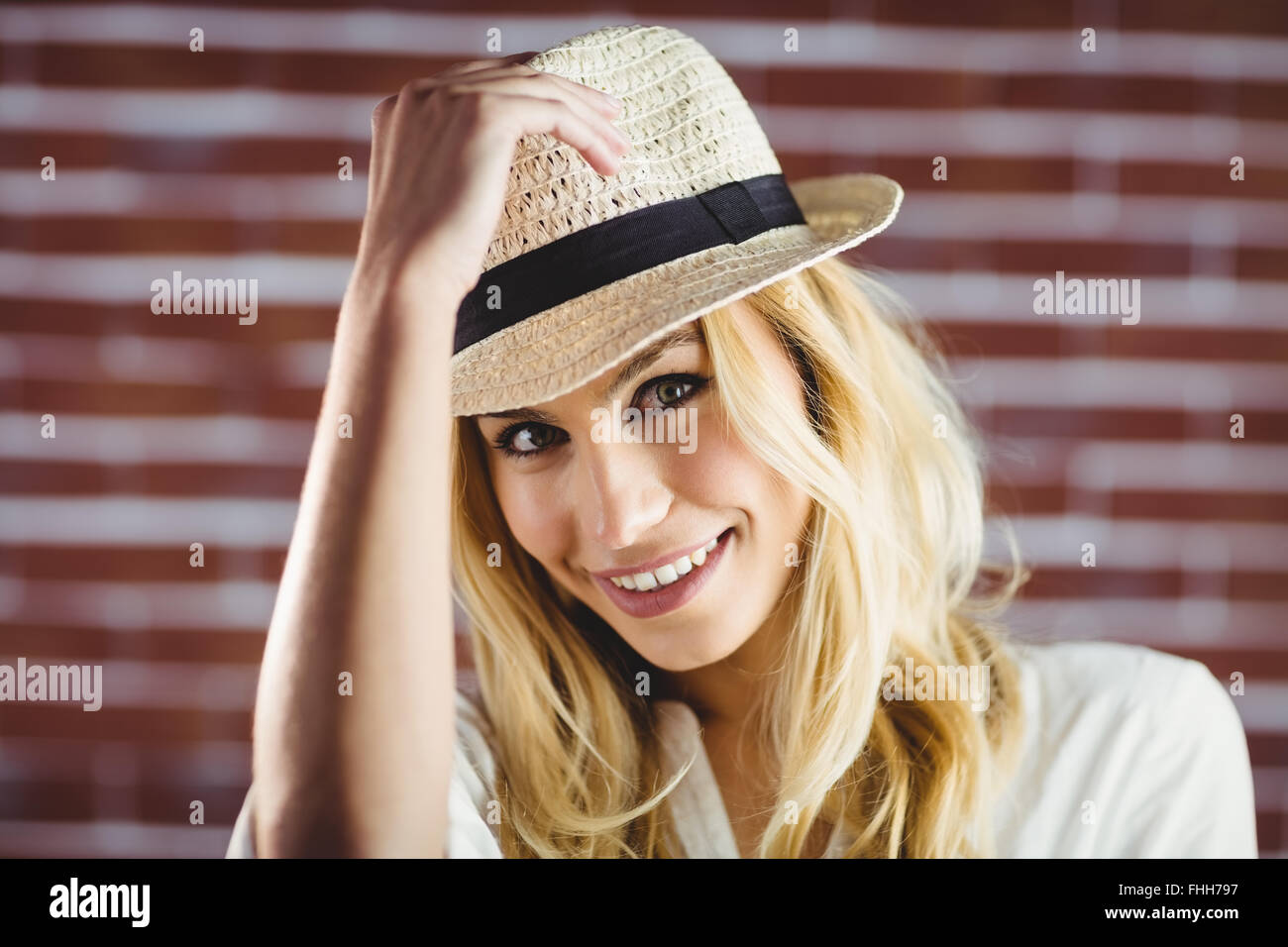 Woman standing holding hat hi-res stock photography and images - Alamy