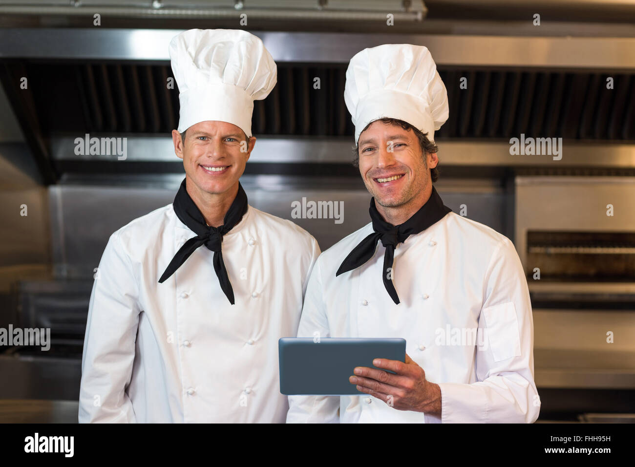 Team of chefs with tablet pc Stock Photo - Alamy