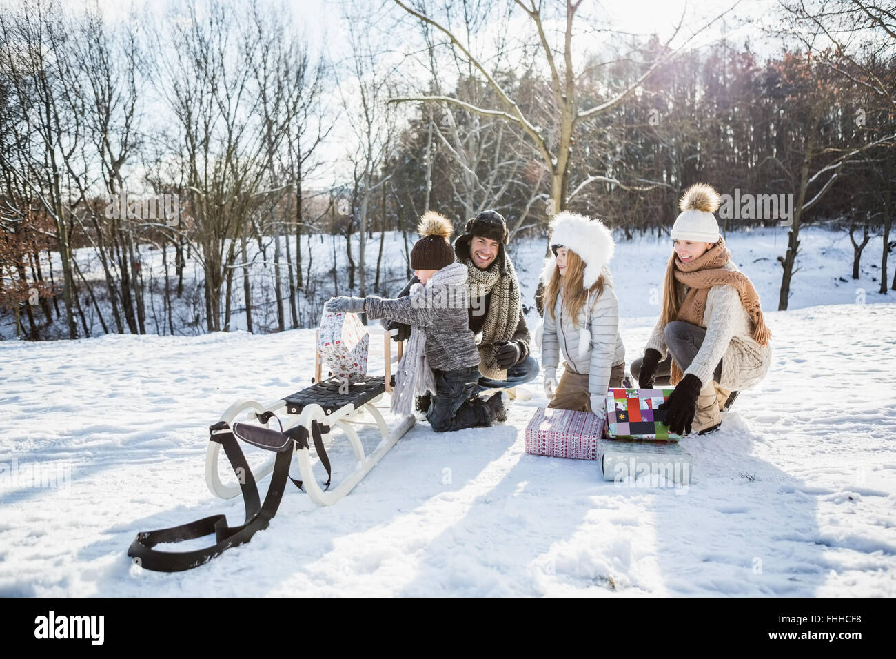 Family playing with sled Stock Photo - Alamy