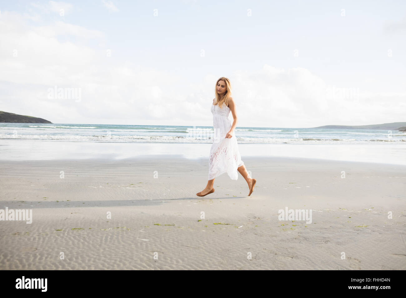 Beautiful blonde woman walking Stock Photo - Alamy
