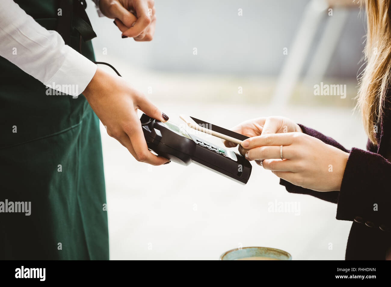 Woman paying with mobile phone Stock Photo - Alamy