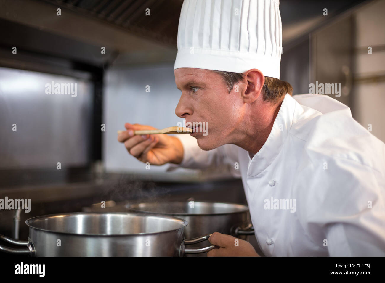 Happy chef tasting his dish Stock Photo - Alamy