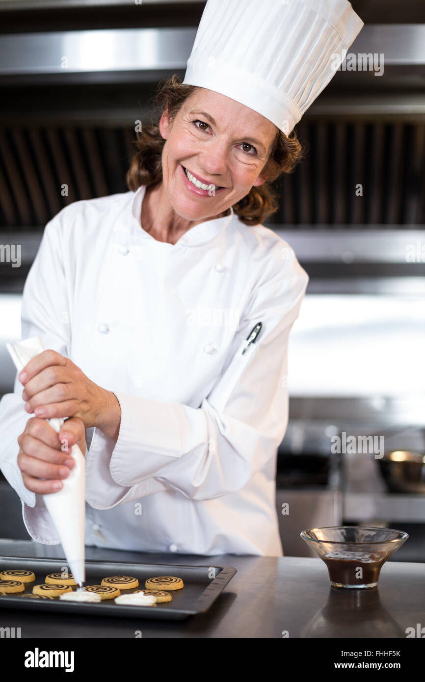 Female chef preparing biscuits hi-res stock photography and images - Alamy