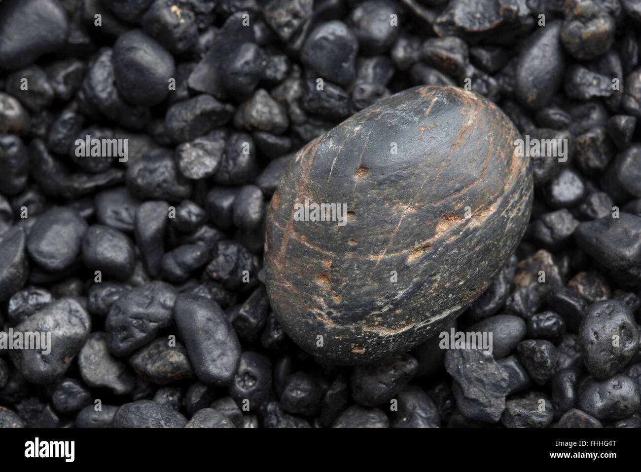 Closeup of dark stones for a background Stock Photo - Alamy