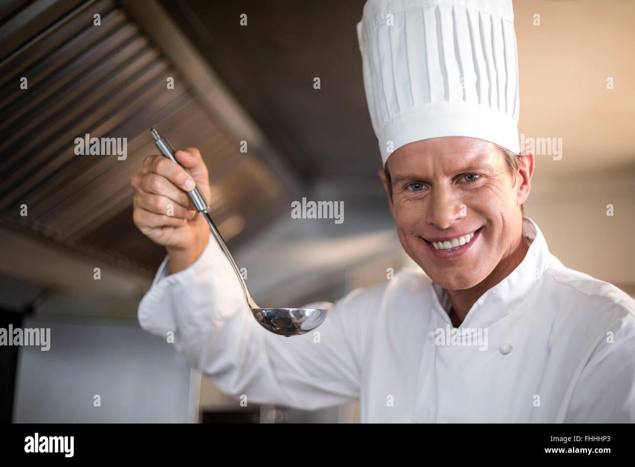 Happy chef tasting his dish Stock Photo - Alamy
