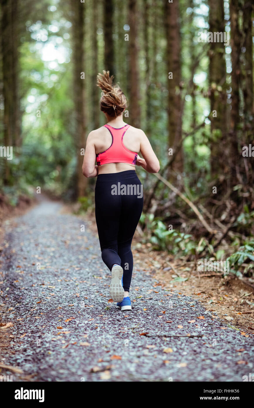 Pretty blonde woman running Stock Photo - Alamy