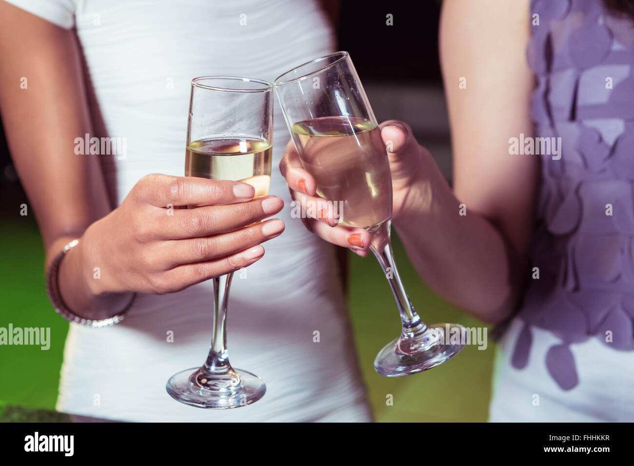 Young women toasting champagne flute Stock Photo - Alamy