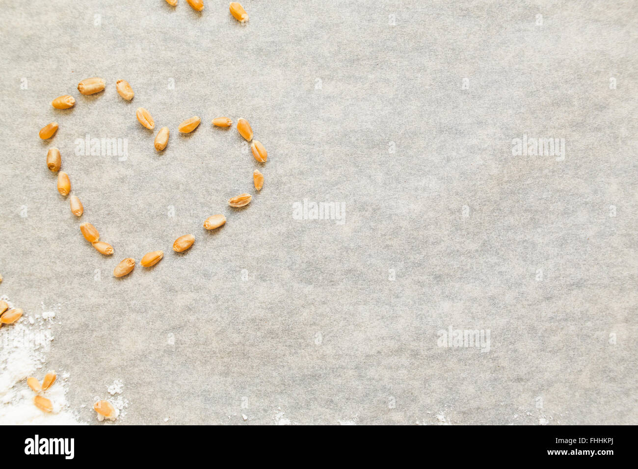 Baking background with heart from wheat grain Stock Photo - Alamy
