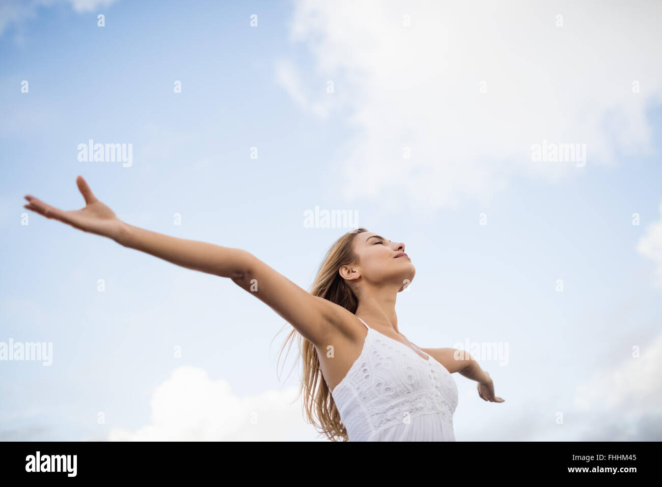 Beautiful blonde woman with arms outstretched Stock Photo - Alamy