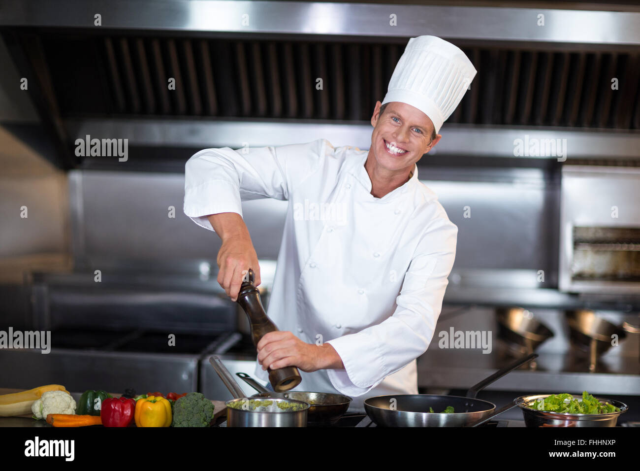 Happy chef seasoning his dish Stock Photo - Alamy