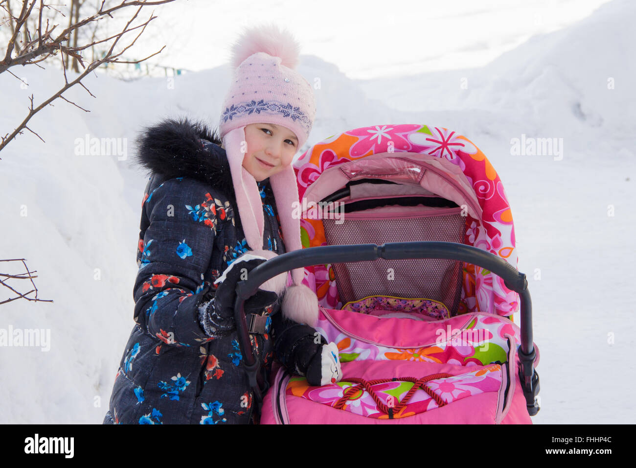 Little girl walking with the stroller Stock Photo - Alamy