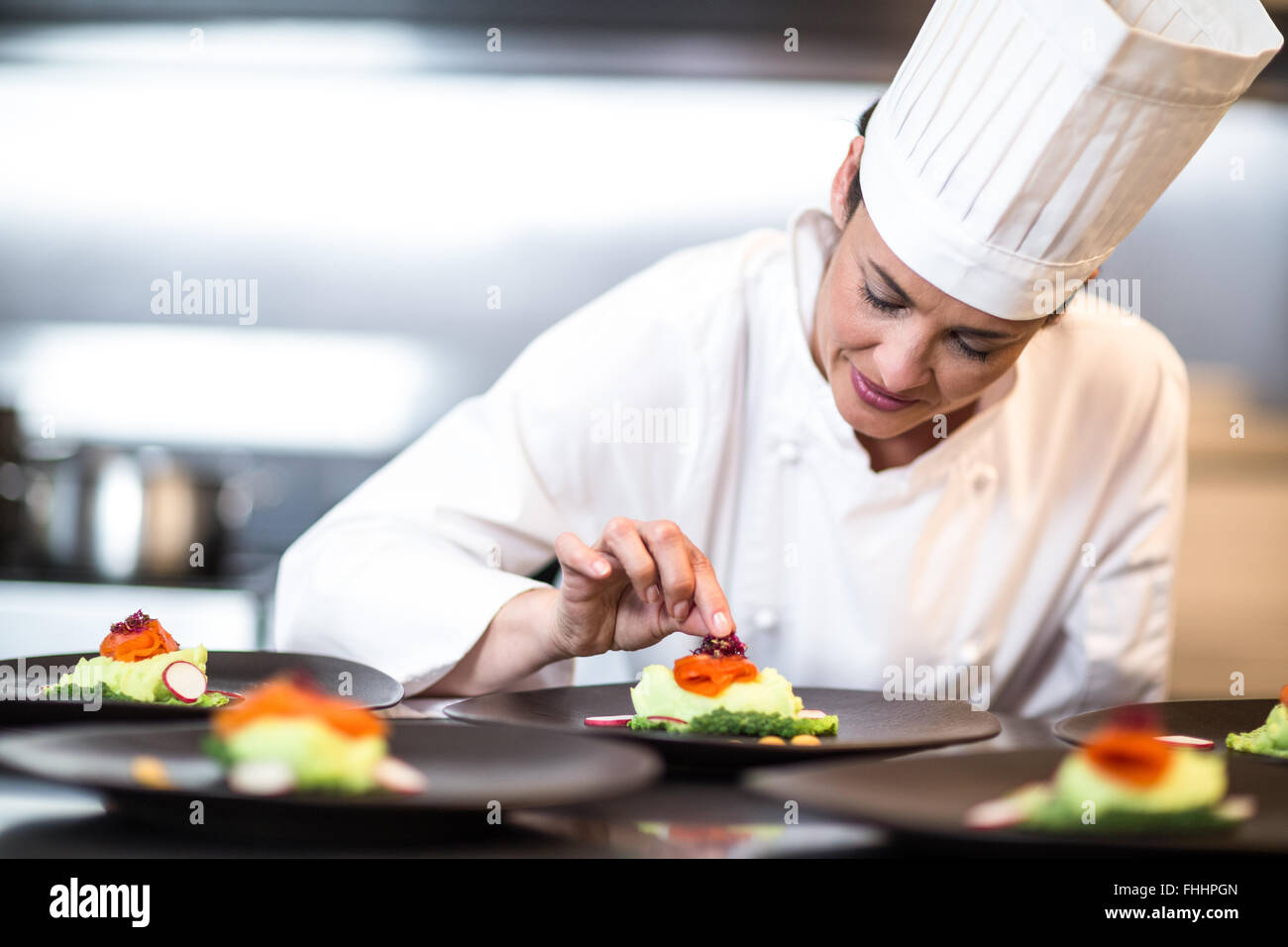 Happy chef with her dishes Stock Photo - Alamy