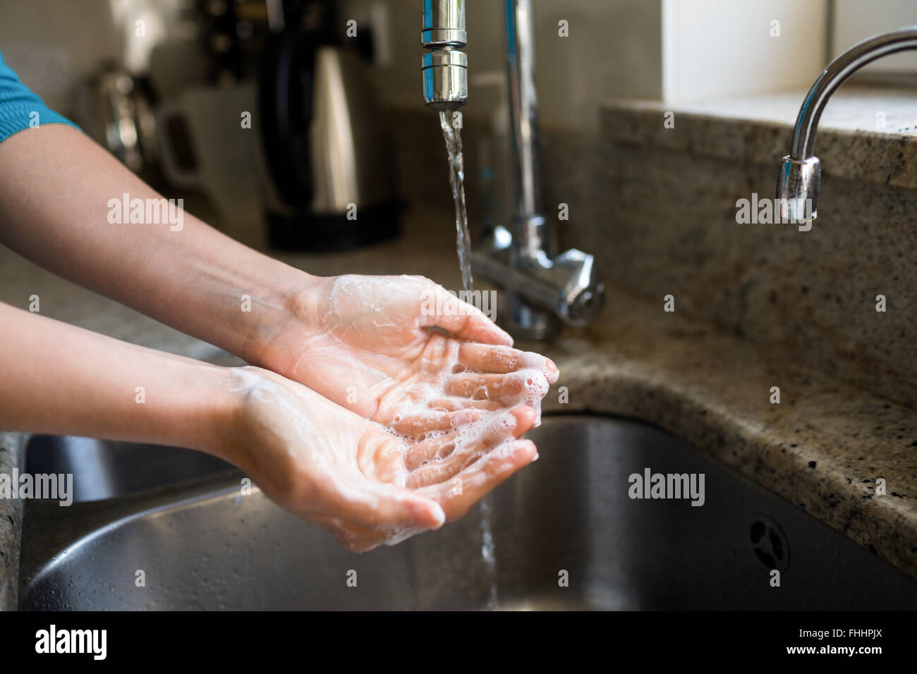 Pretty woman washing her hands Stock Photo - Alamy