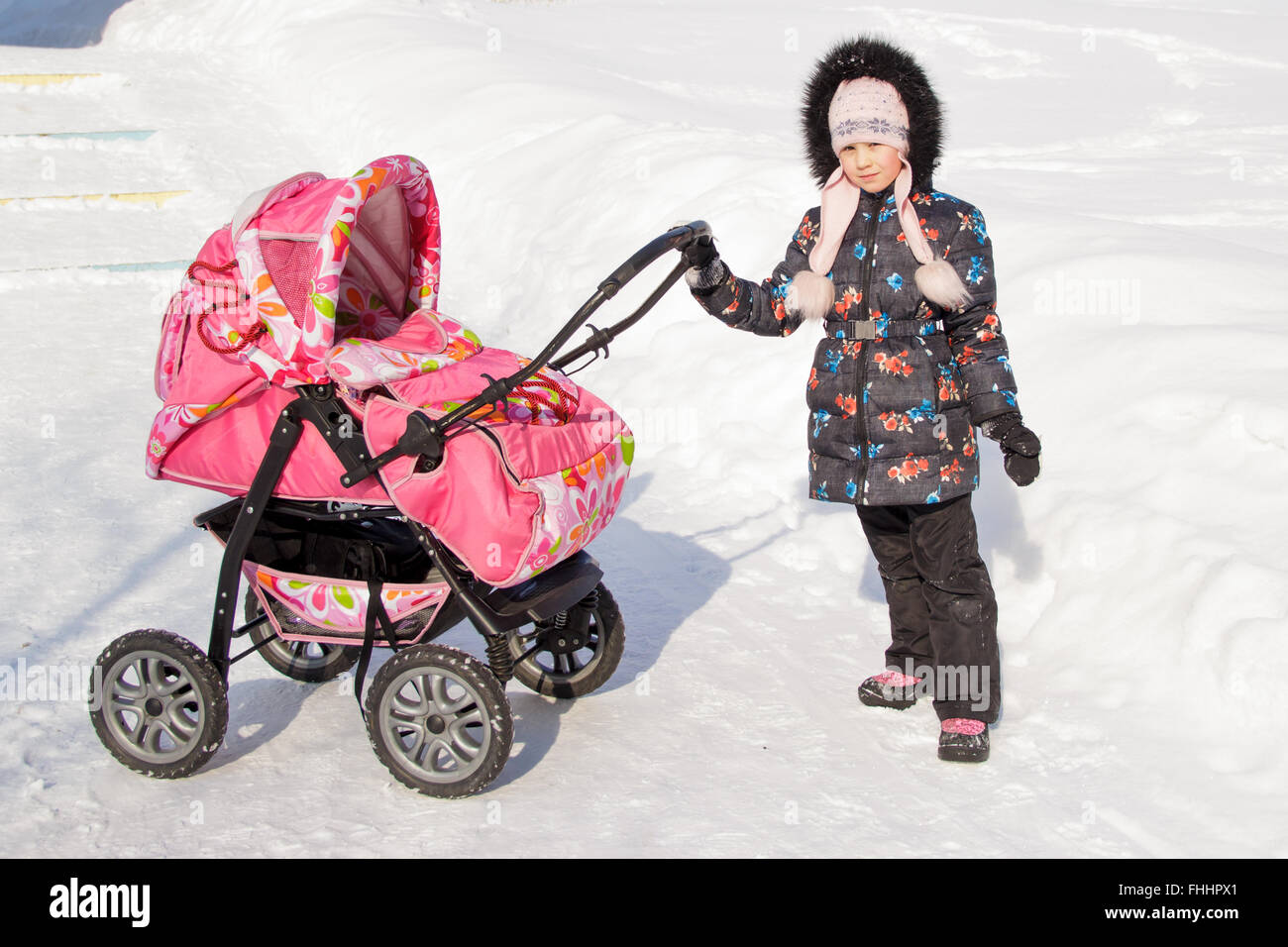 Little girl walking with the stroller Stock Photo - Alamy