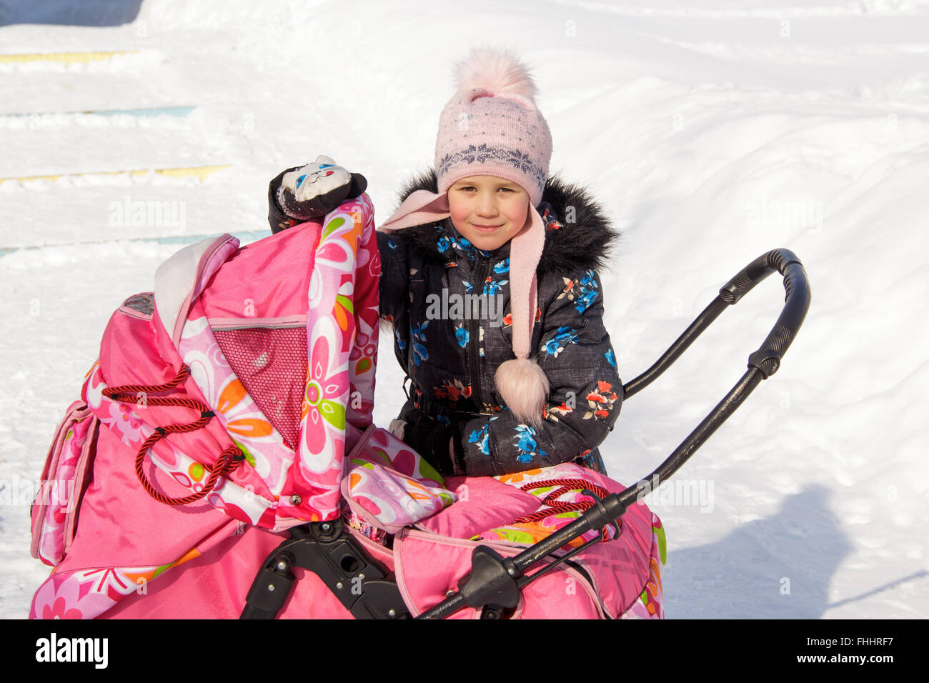 Little girl walking with the stroller Stock Photo - Alamy