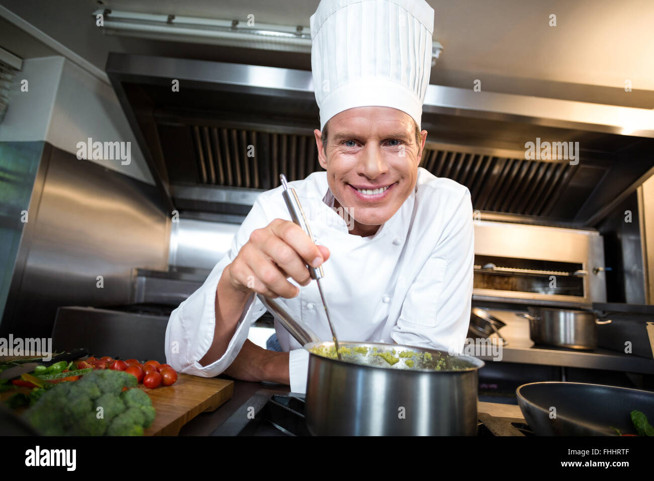 Happy chef smiling at camera Stock Photo - Alamy