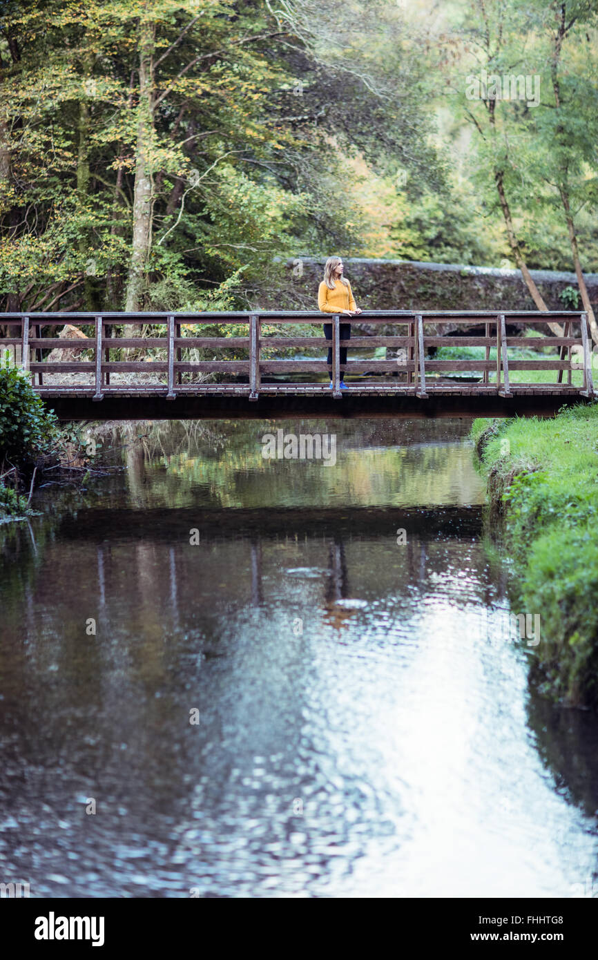 Pretty woman standing on a bridge Stock Photo - Alamy