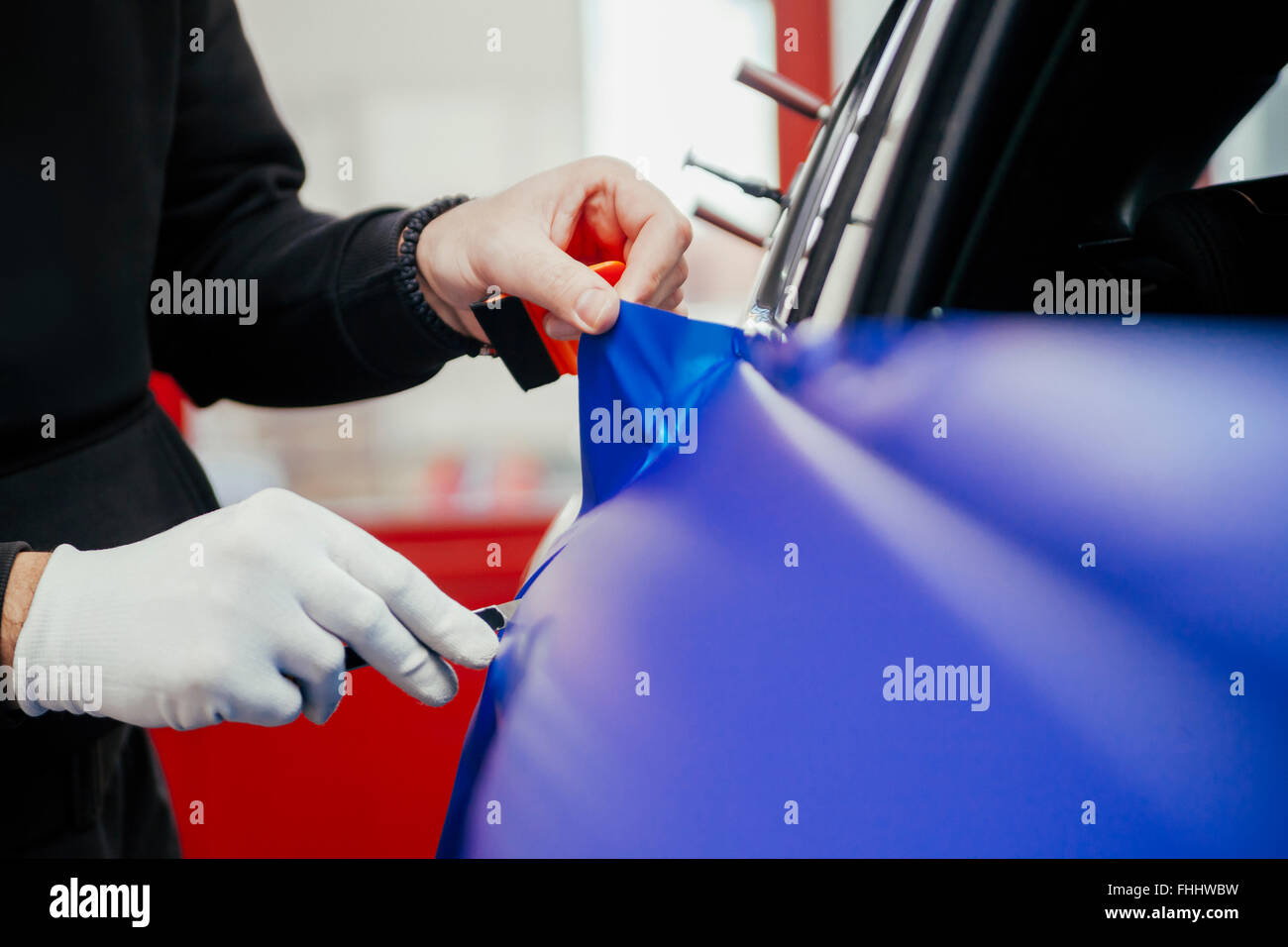 Man wrapping car with vinyl foil Stock Photo - Alamy