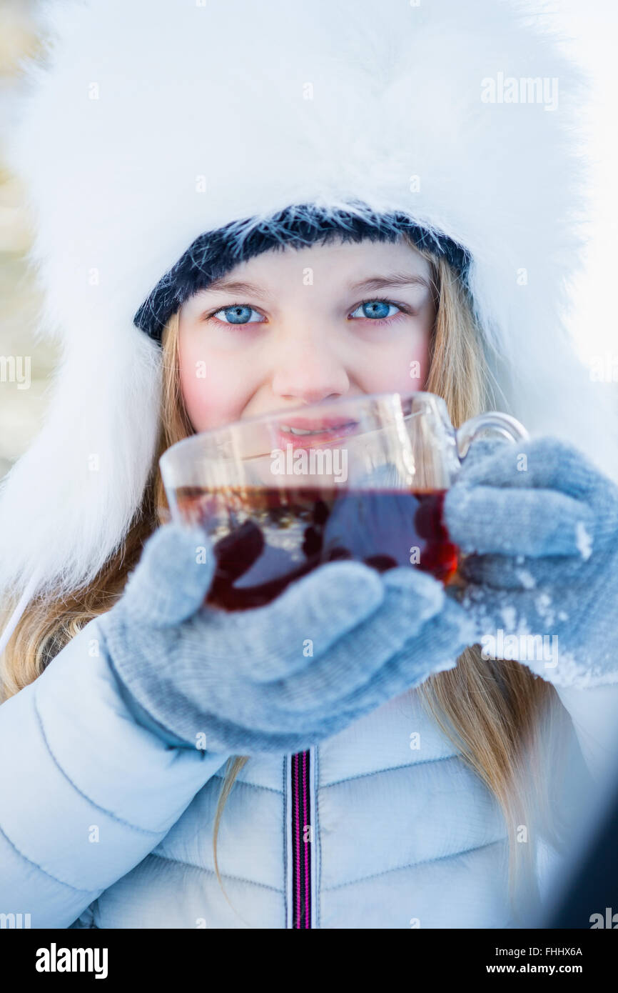 Cute girl drinking hot tea Stock Photo - Alamy