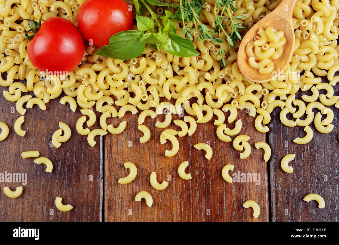 Raw Chifferi pasta background on the wooden table Stock Photo - Alamy