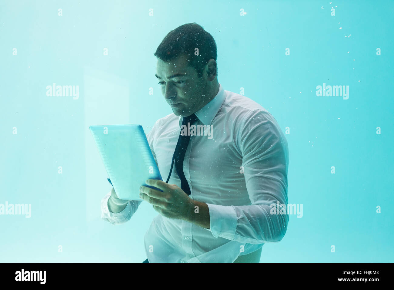 Businessman using tablet pc underwater Stock Photo - Alamy