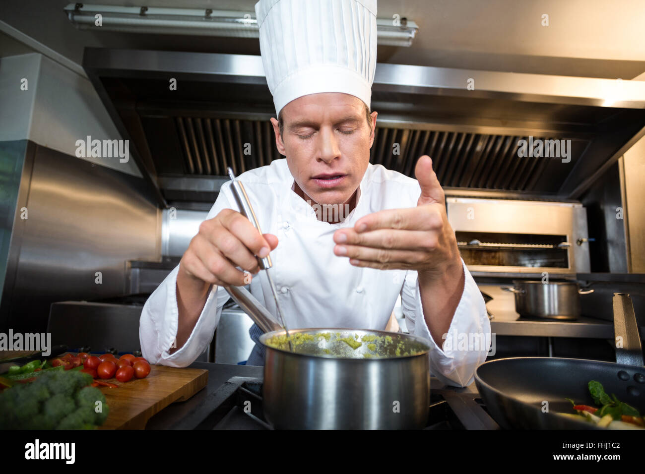 Happy chef smelling his dish Stock Photo - Alamy