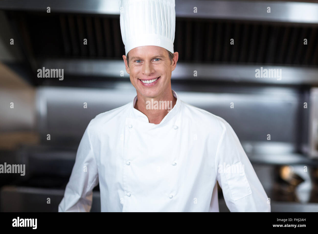 Happy chef smiling at camera Stock Photo - Alamy