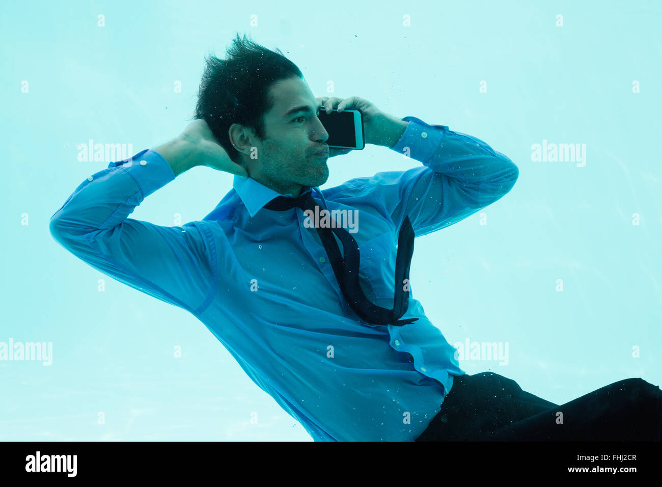 Businessman on the phone underwater Stock Photo - Alamy