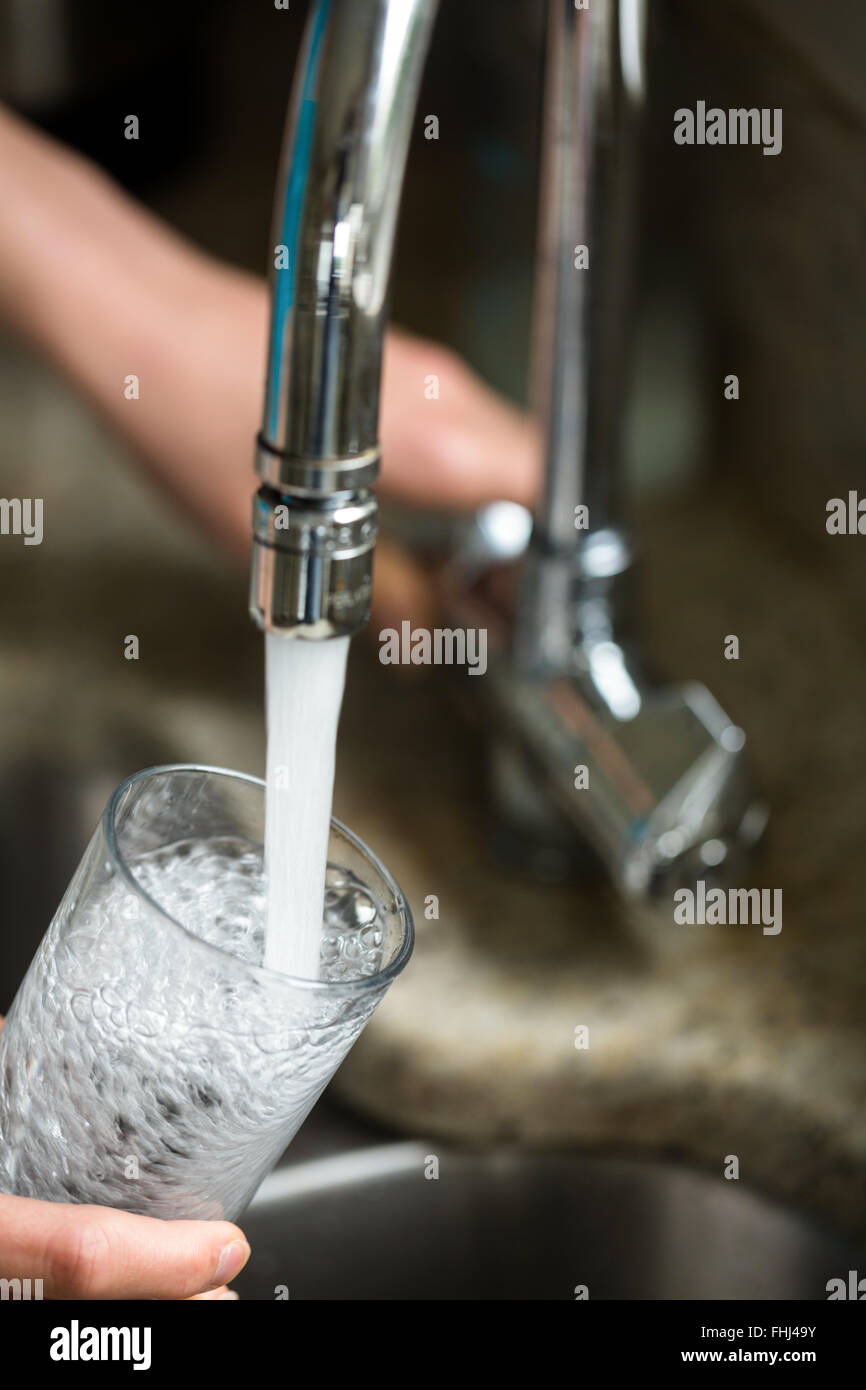 Woman pouring water glass hi-res stock photography and images - Alamy