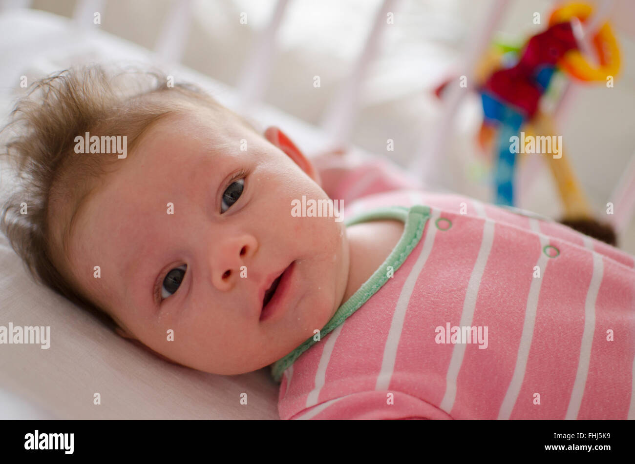 Baby girl in cot hi-res stock photography and images - Alamy