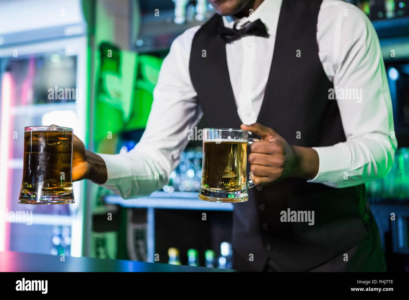 Bartender serving two hi-res stock photography and images - Alamy