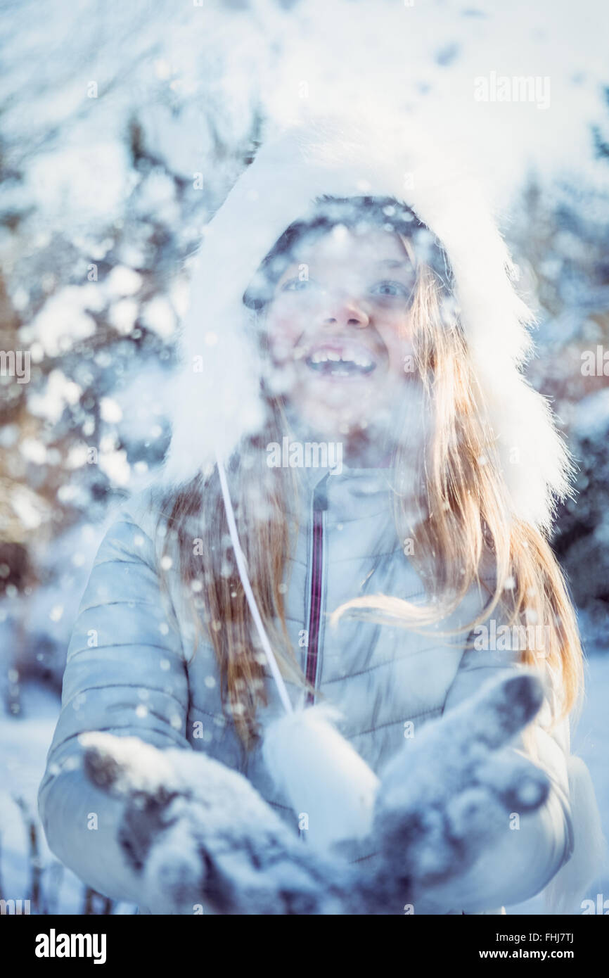 Cute girl throwing snowflake Stock Photo - Alamy