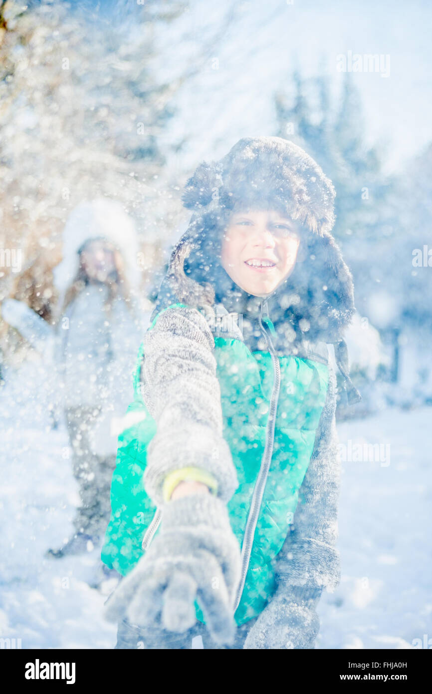 Sibling throwing snowflake together Stock Photo - Alamy