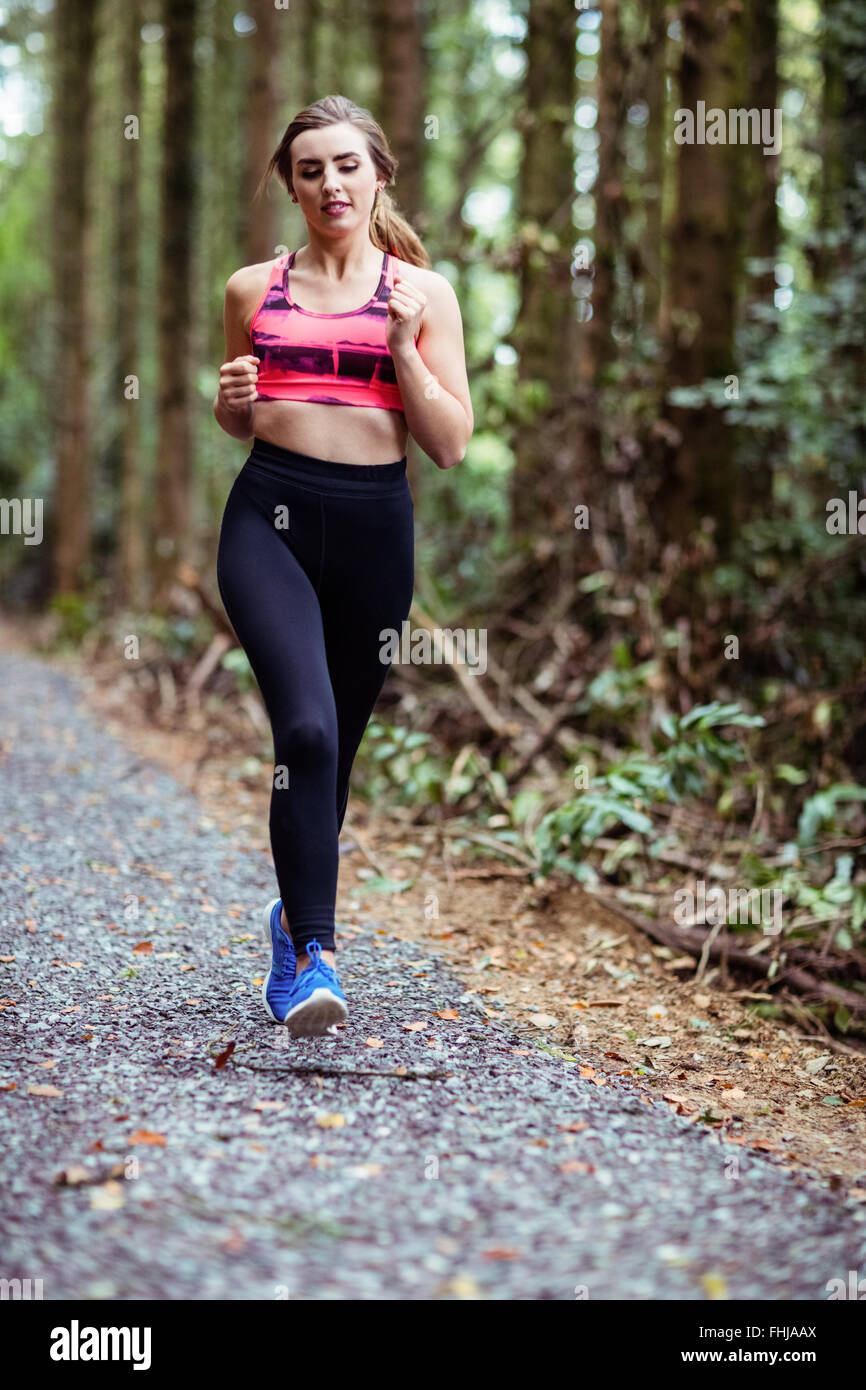 Pretty blonde woman running Stock Photo - Alamy