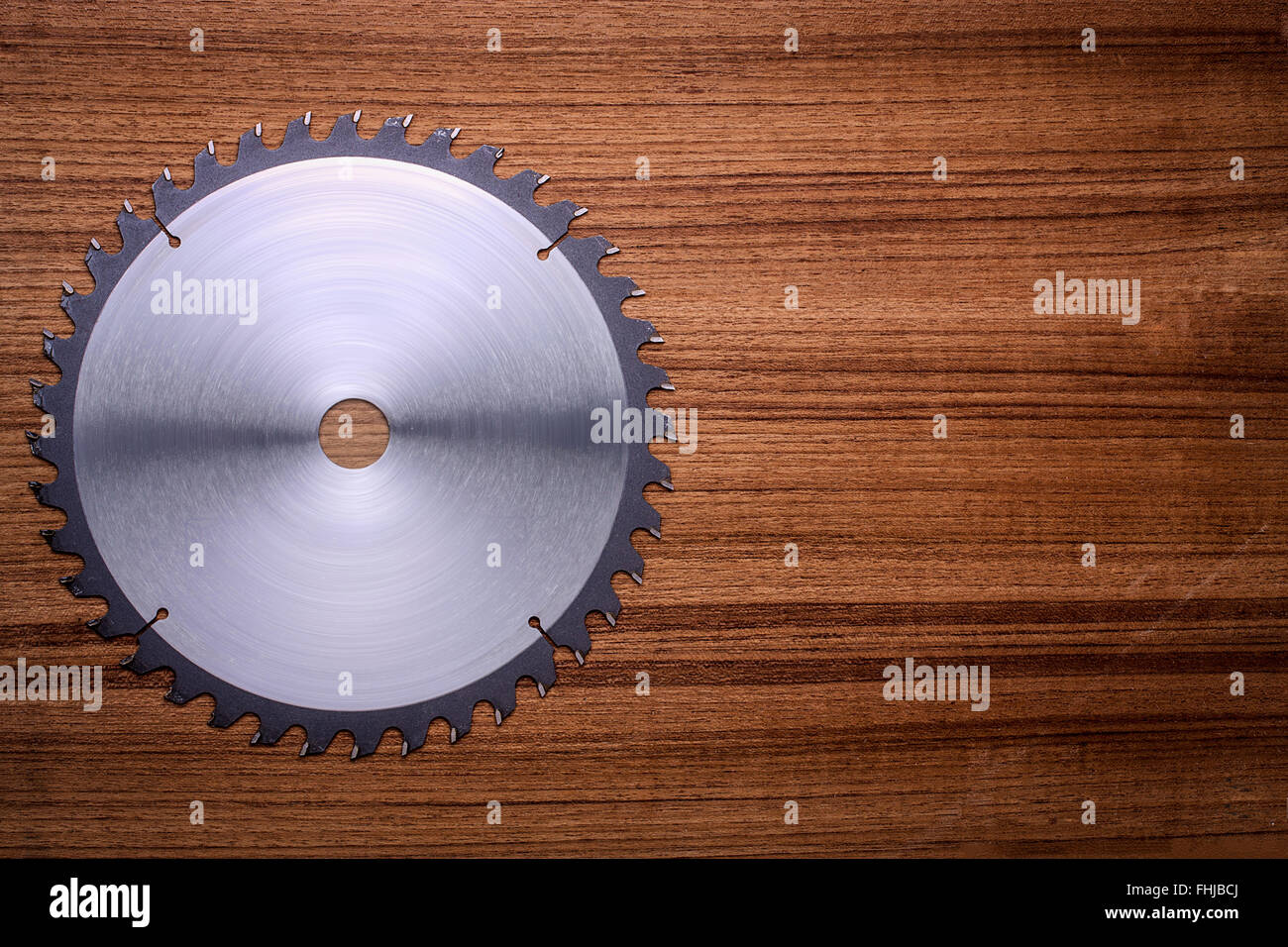 Circular saw blade on wooden background with copy space Stock Photo - Alamy