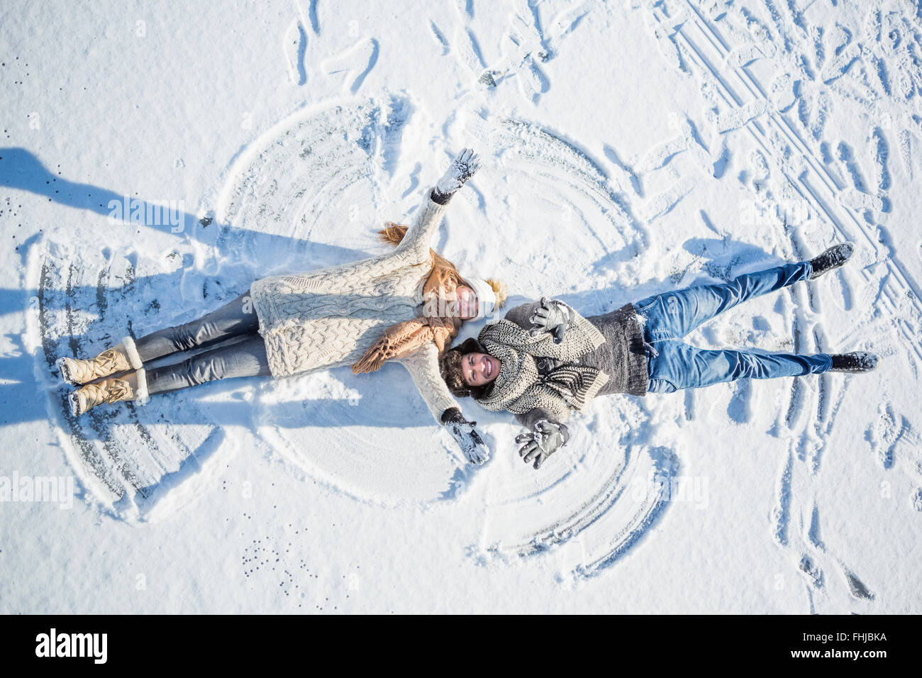 Couple doing snow angel Stock Photo - Alamy