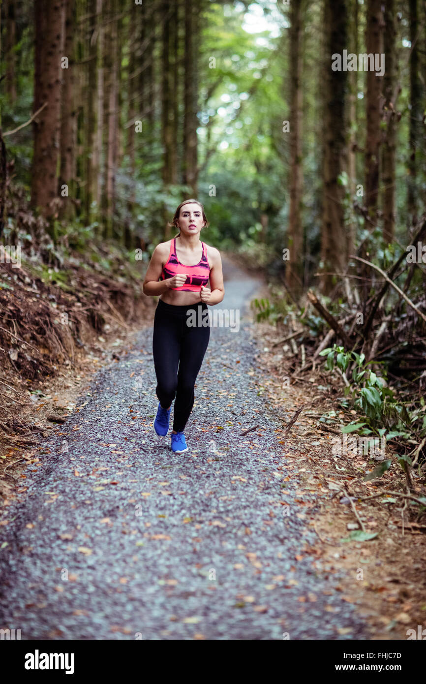 Pretty blonde woman running Stock Photo - Alamy