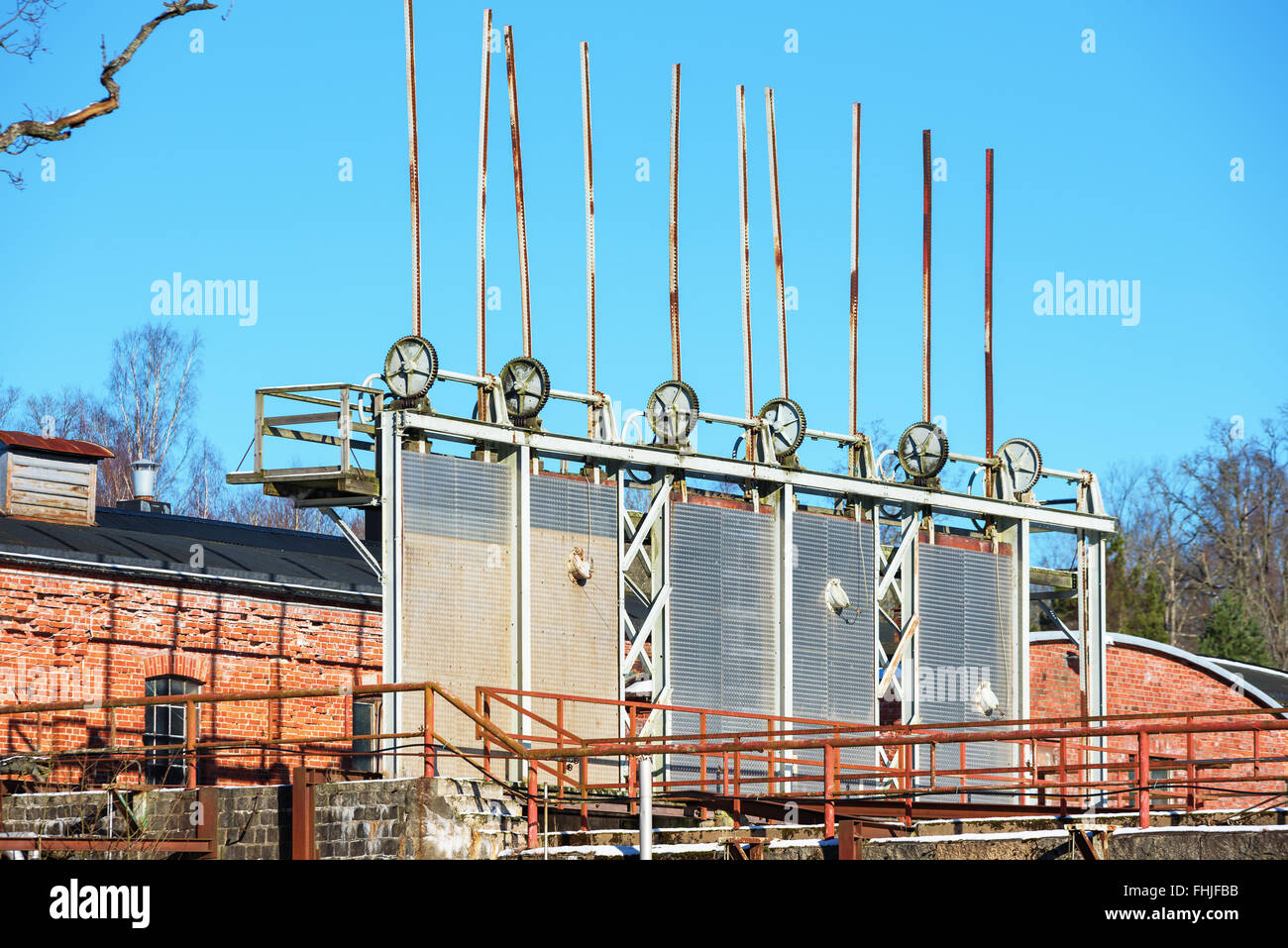 Detail of raised metal water gates at an abandoned paper mill Stock ...