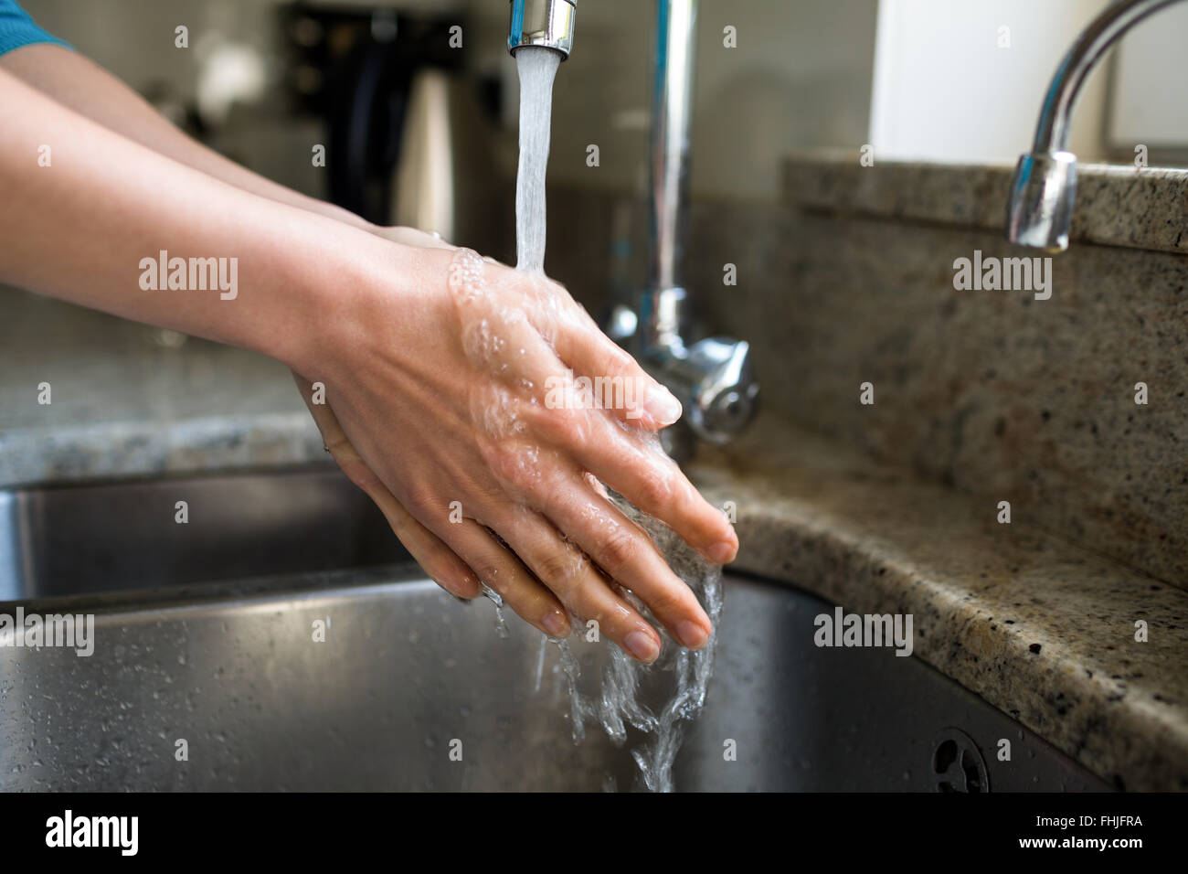 Pretty woman washing her hands Stock Photo - Alamy