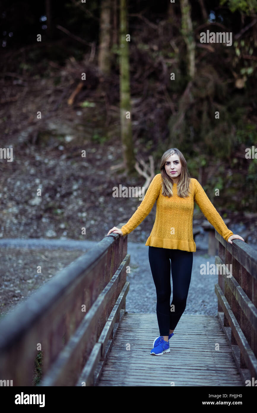 Pretty woman leaning on a barrier Stock Photo - Alamy