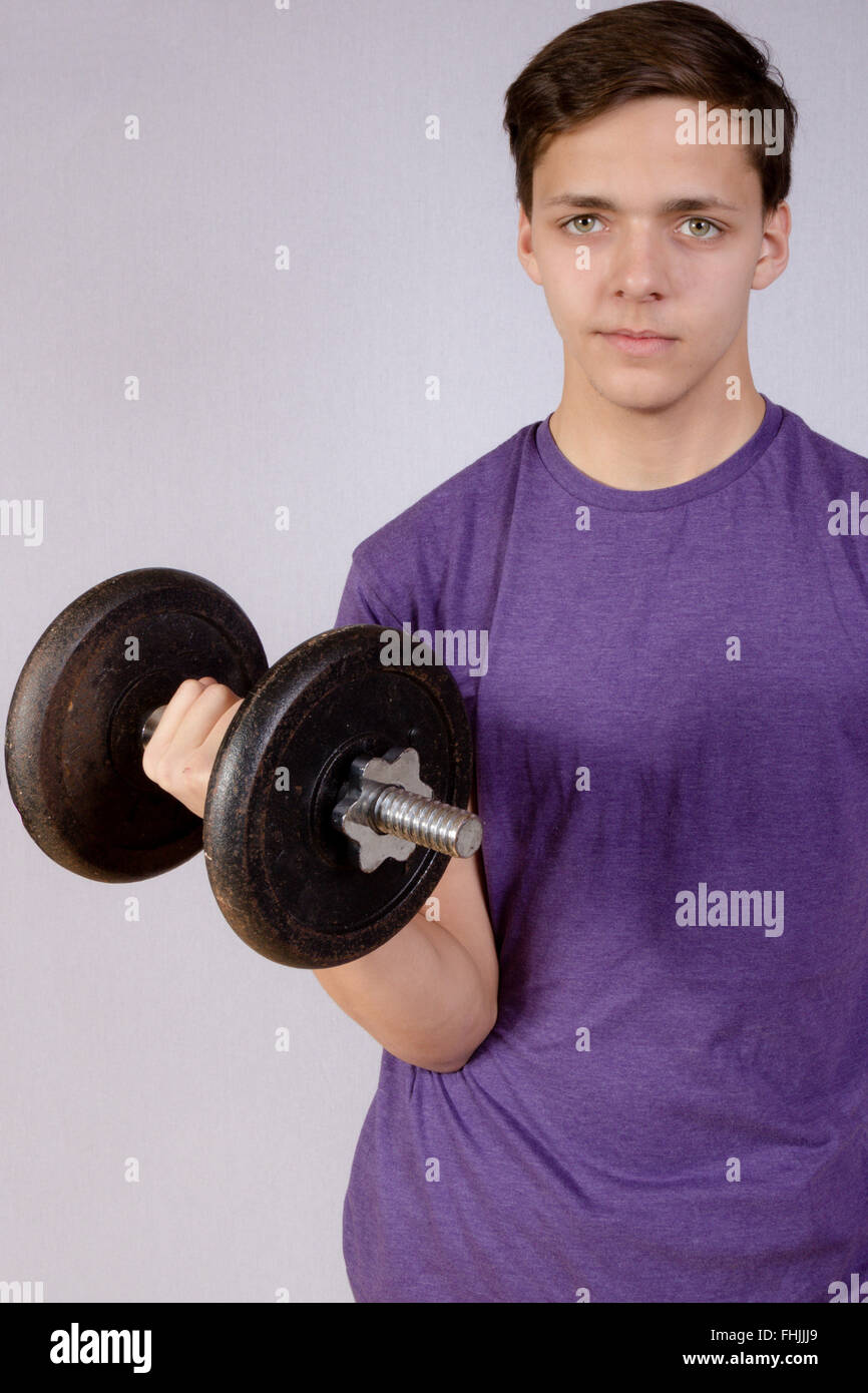 Teen boy lifting weights hi-res stock photography and images - Alamy