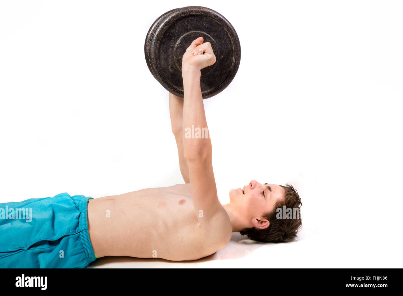 Shirtless Teenage Boy Lifting weights Stock Photo - Alamy