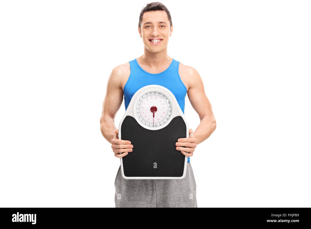 Studio shot of a young athlete holding a weight scale isolated on white ...