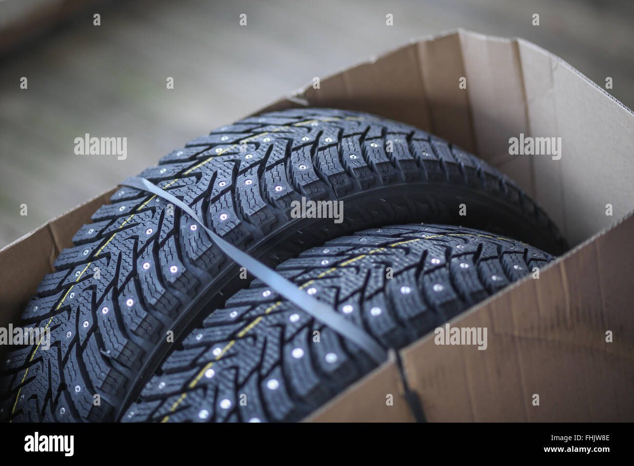 Studded tire on a gray background Stock Photo - Alamy