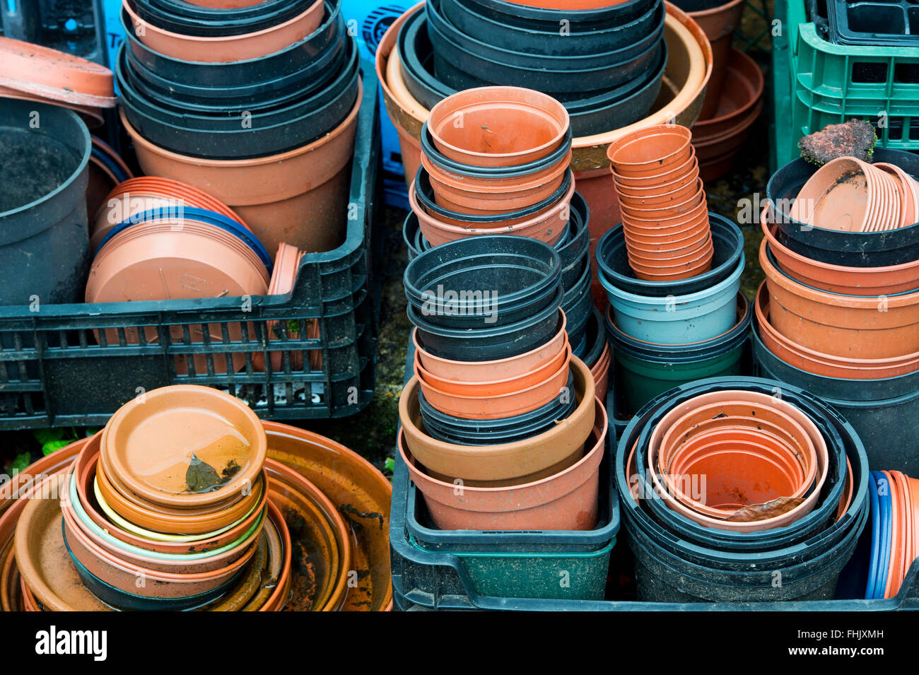 Assorted flower pots in a garden Stock Photo - Alamy